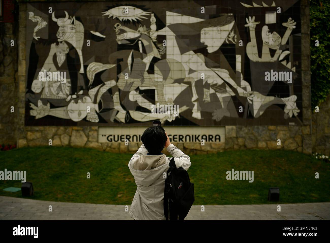 A visitor takes photos of a wall decorated with the famous Pablo ...