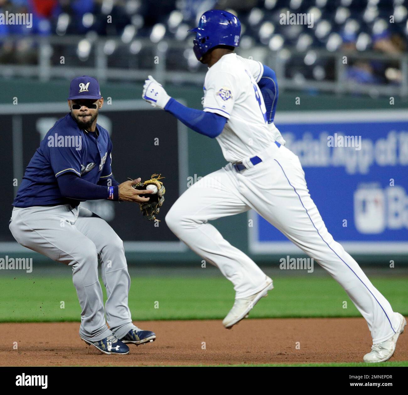Milwaukee Brewers second baseman Jonathan Villar, left, throws out ...