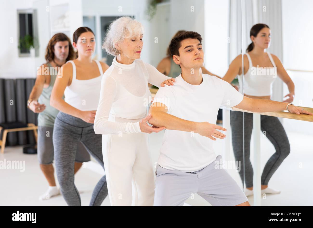 Dancer man learn ballet elements with choreographer during group ...