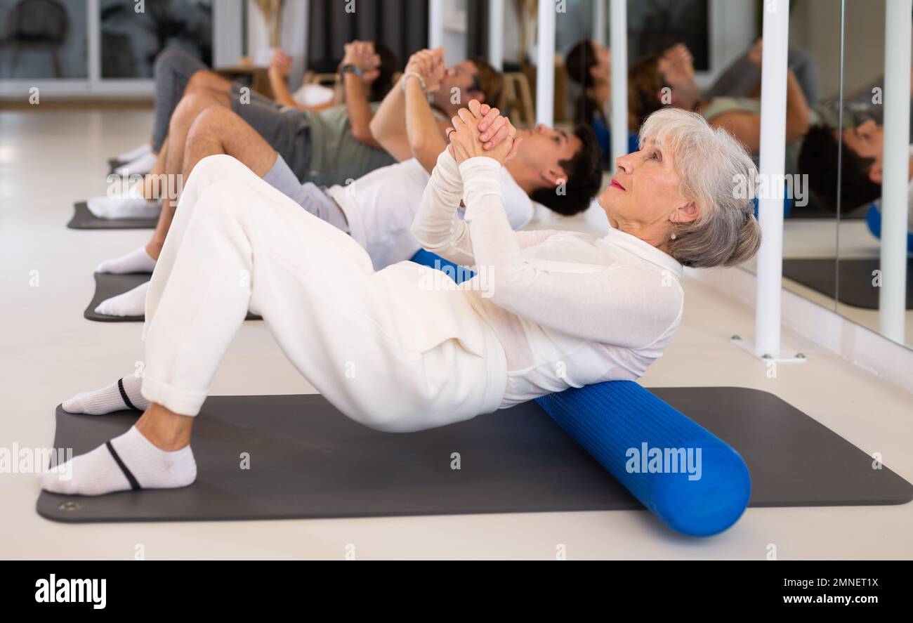 Group of people doing hip bridge exercise in gym Stock Photo - Alamy
