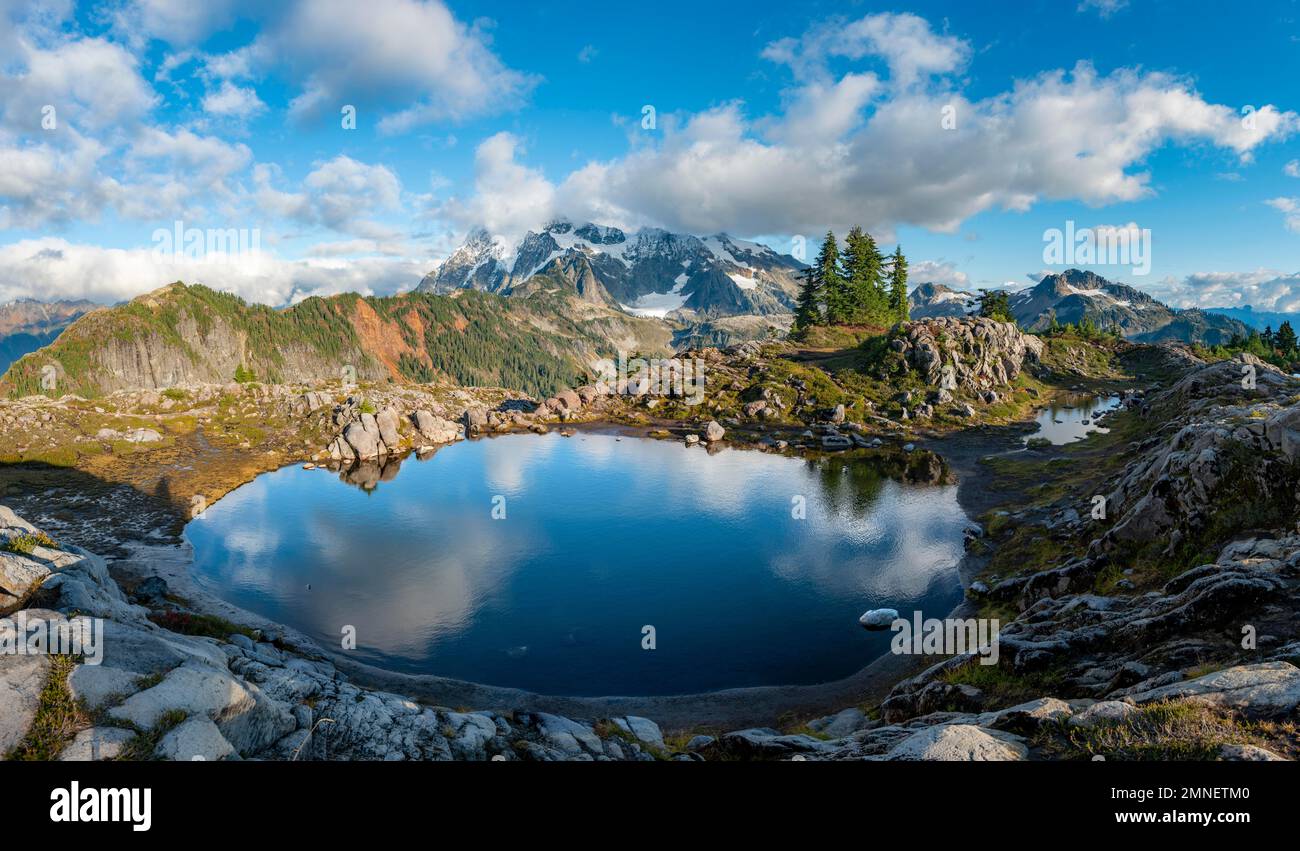 Lake at Huntoon Point, view of cloudy Mt. Shuksan with glacier and snow ...