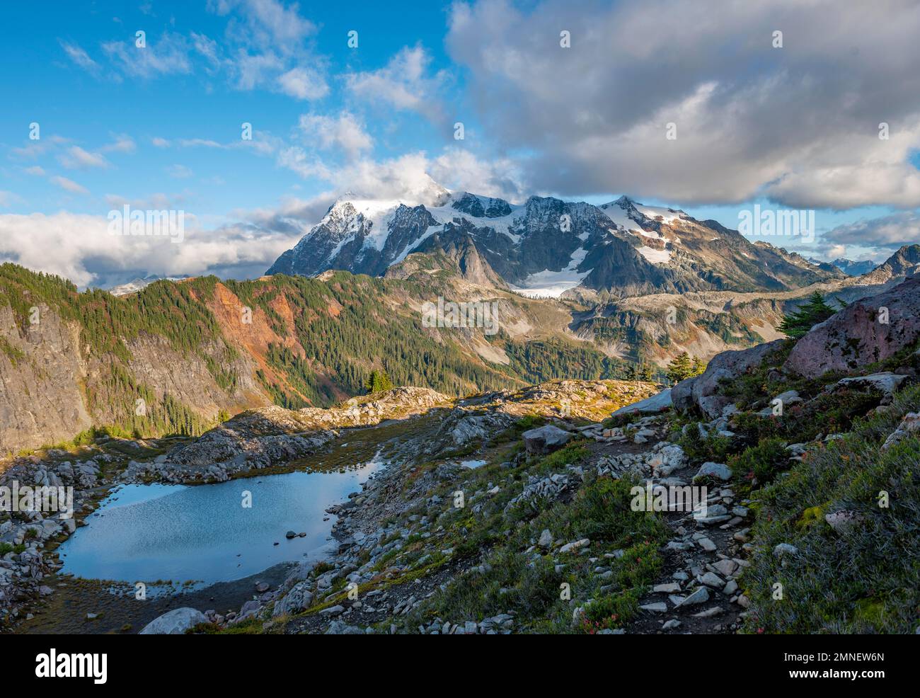 Lake at Huntoon Point, view of cloudy Mt. Shuksan with glacier and snow ...