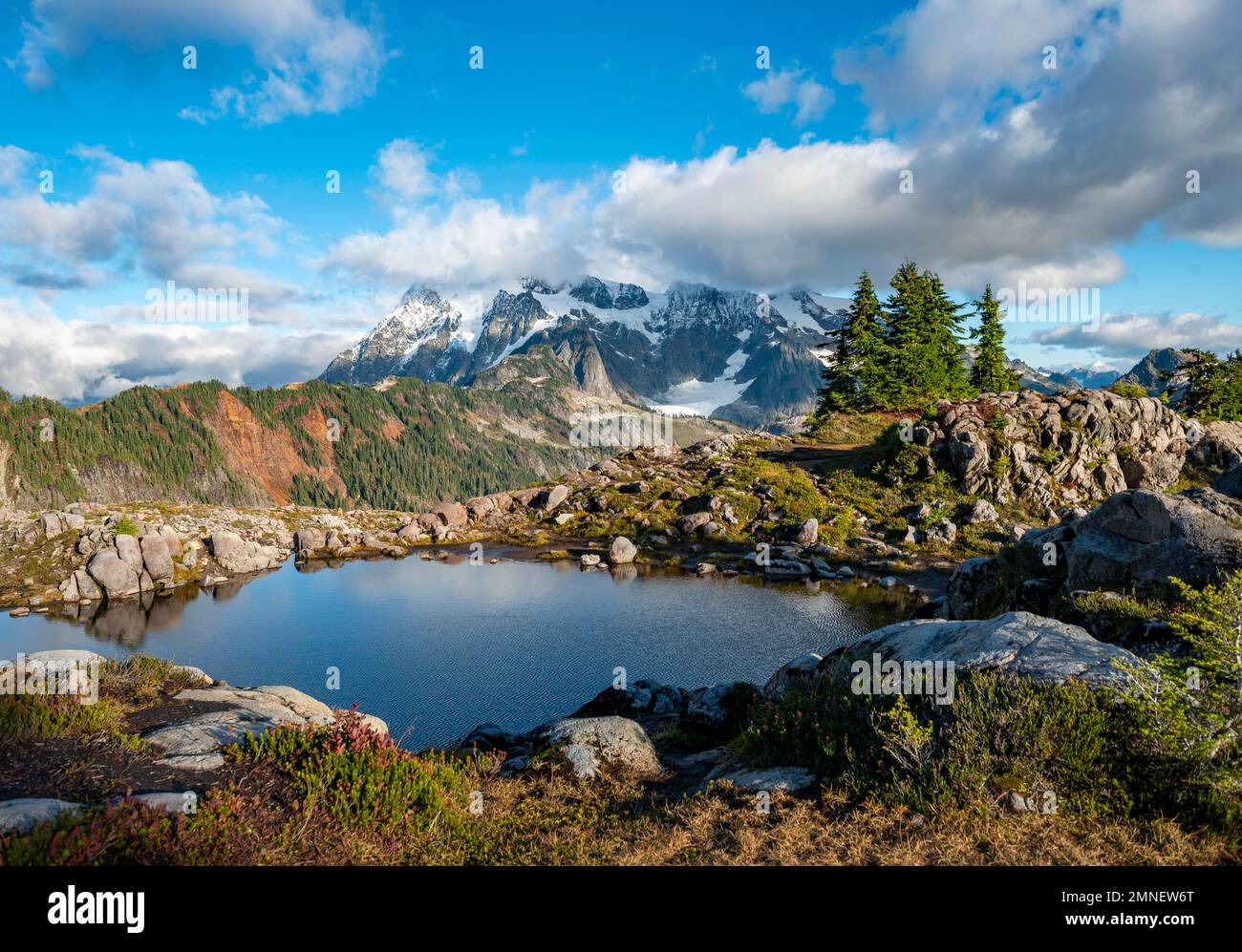 Lake at Huntoon Point, view of cloudy Mt. Shuksan with glacier and snow ...