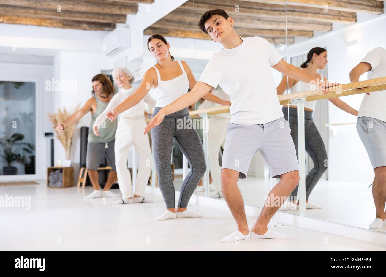 Group of different people doing ballet at barre Stock Photo - Alamy