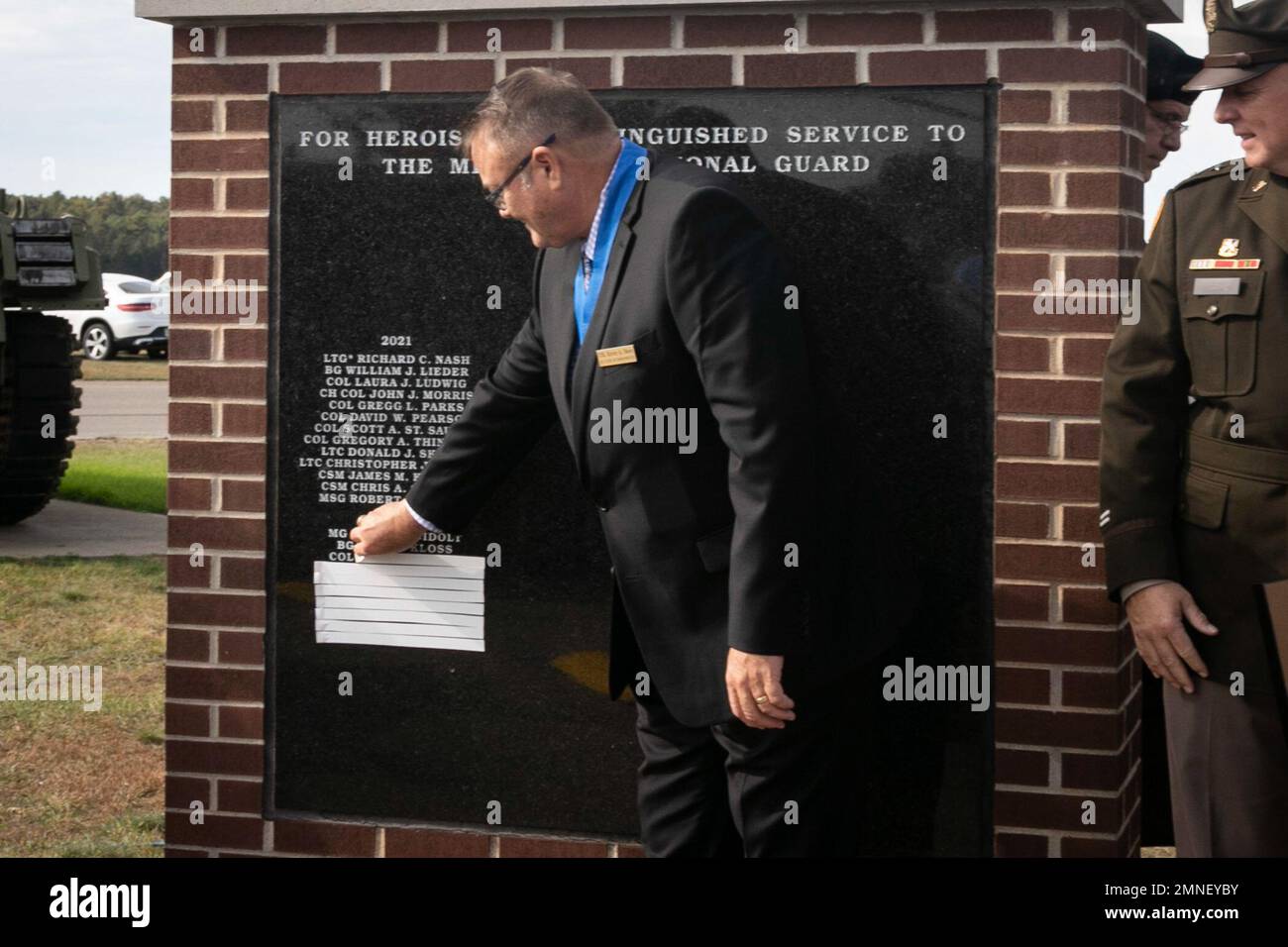 Retired Col. Kevin A. Olson removes the cover from his name inscribed ...