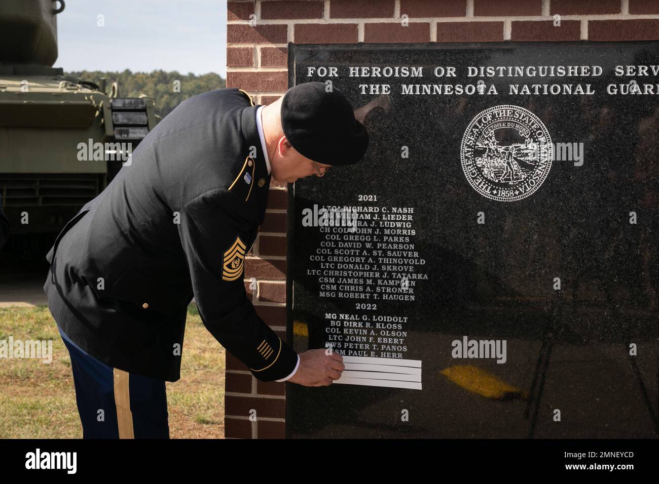 Minnesota’s Army Command Sgt. Maj. George Jensen removes the cover from ...