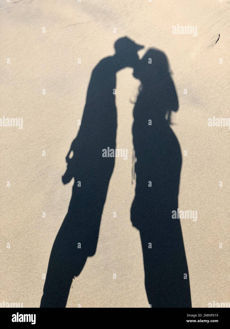 Shadows in the sand, couple kissing, sandy Bastendorff Beach, Oregon ...