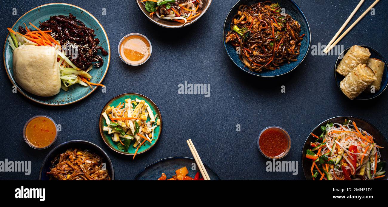 Set of Chinese dishes on table: sweet and sour chicken, fried spring ...