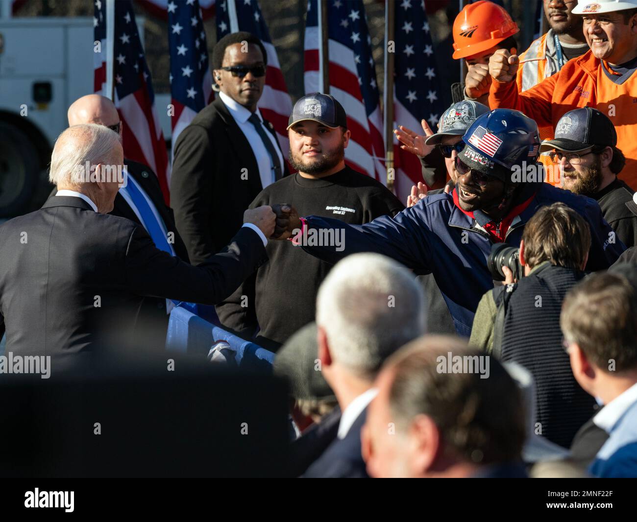 United States President Joe Biden shares a fist bump with an Amtrak ...