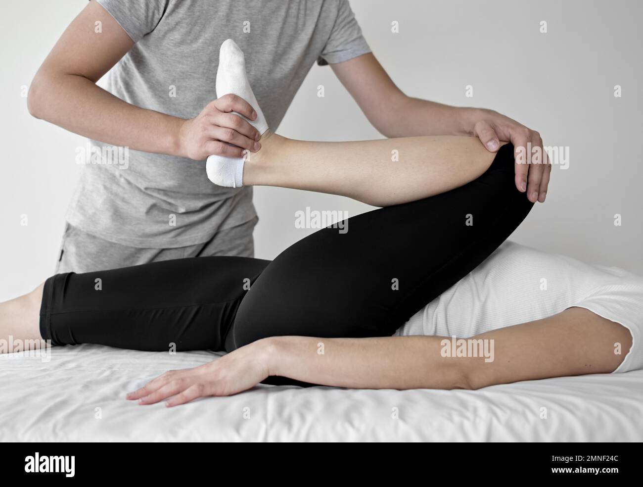 therapist undergoing physical therapy with female patient. Resolution ...