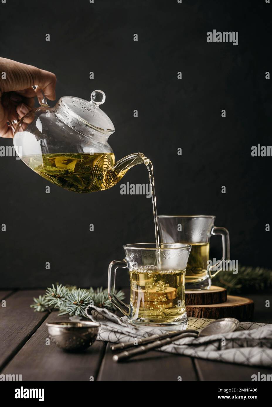 front view hand pouring tea glass with teapot. Beautiful photo Stock ...
