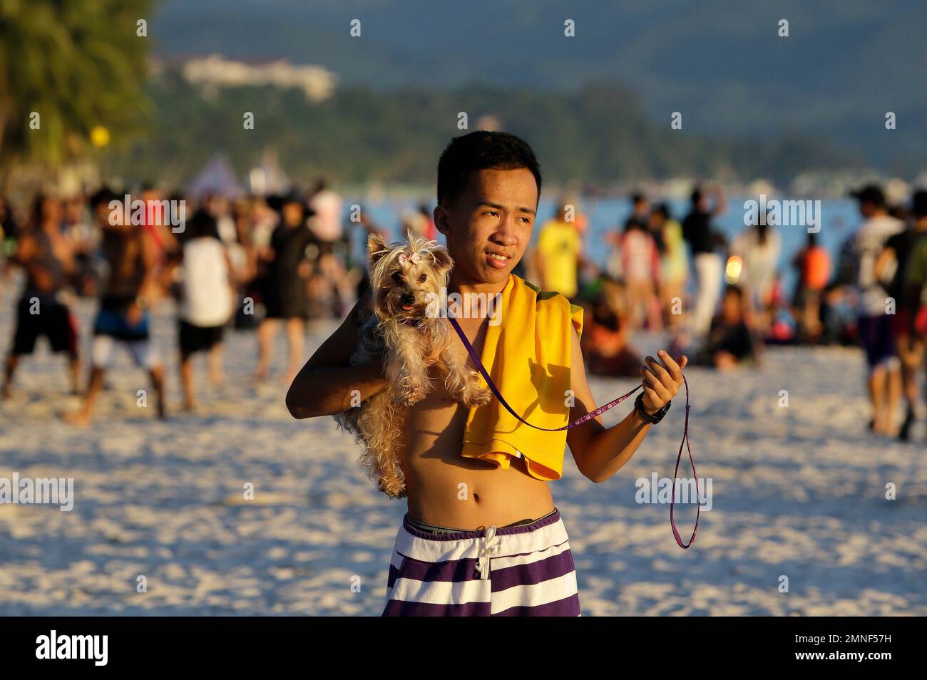 A tourist walks with his dog, on the country's most famous beach resort ...