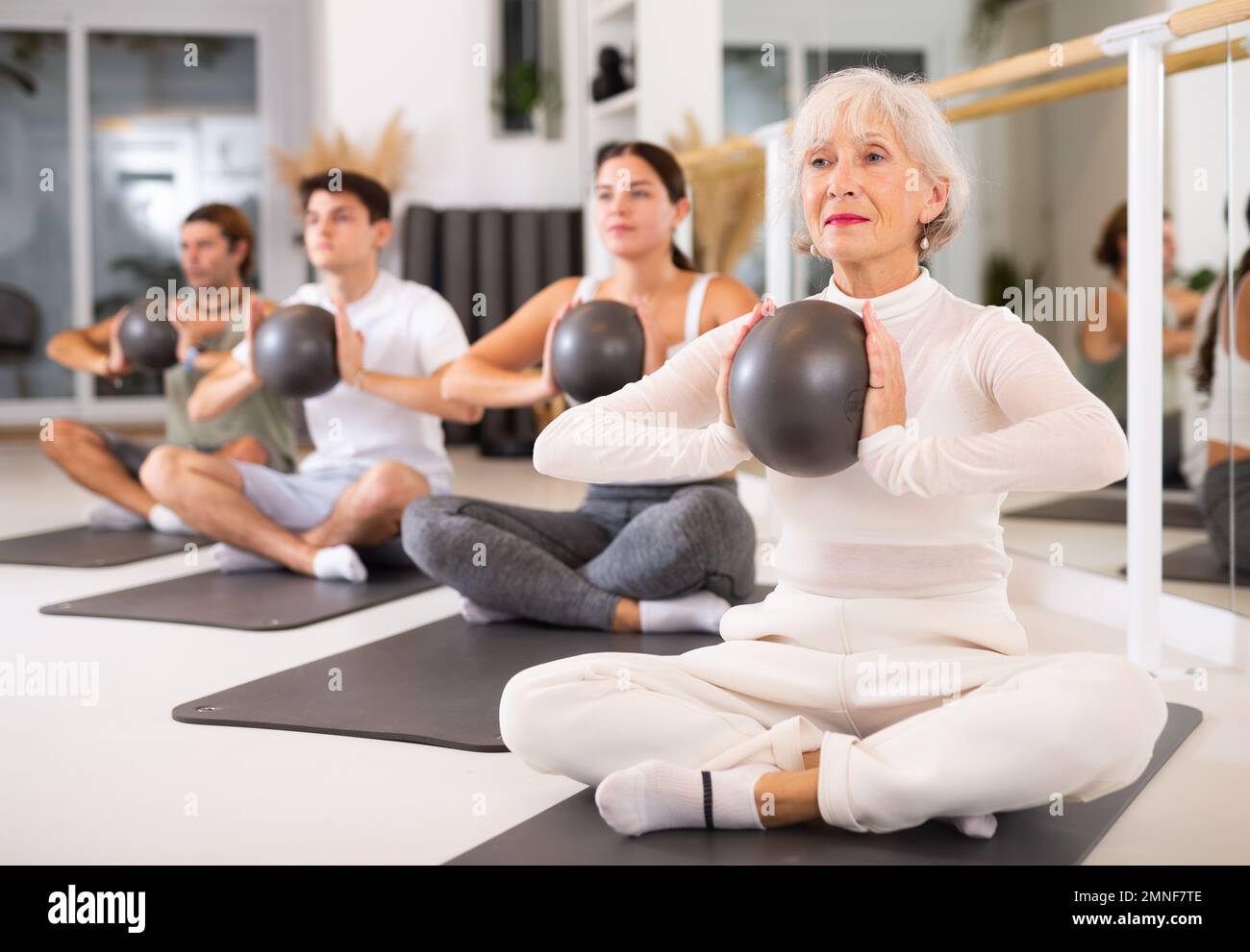 Elderly woman doing pilates with ball Stock Photo - Alamy