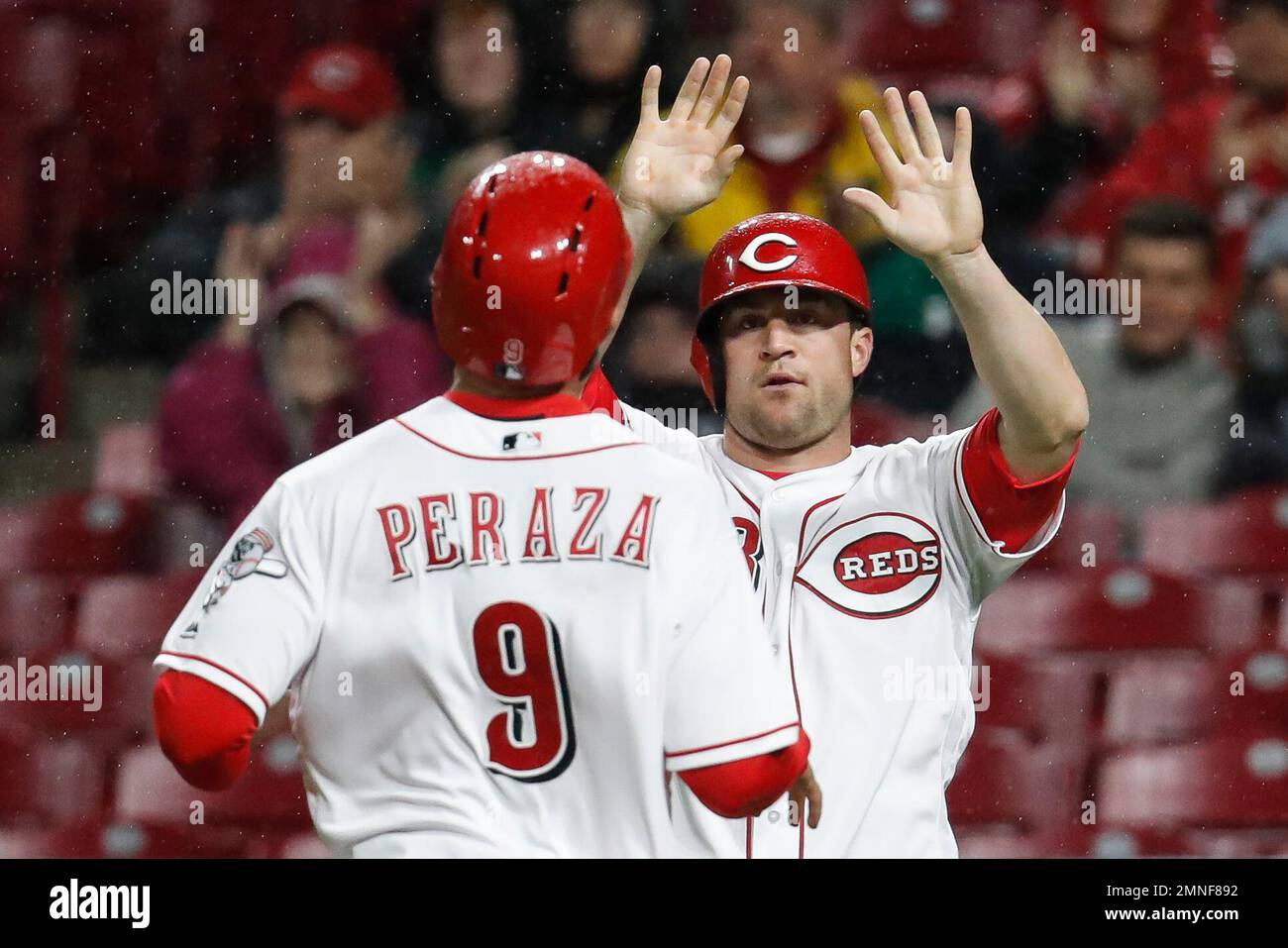 Cincinnati Reds' Scott Schebler, right, celebrates scoring with Jose ...