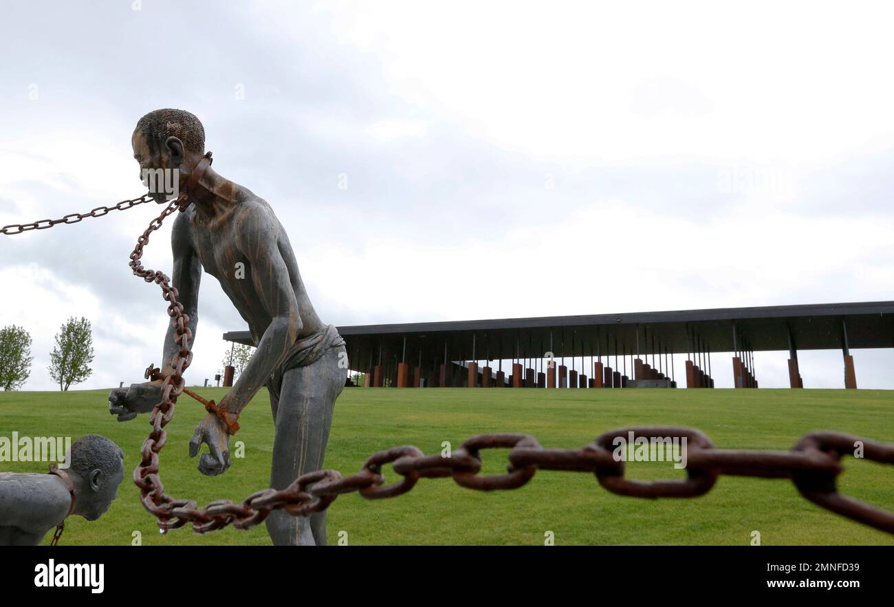 A statue of a chained man is on display at the National Memorial for ...