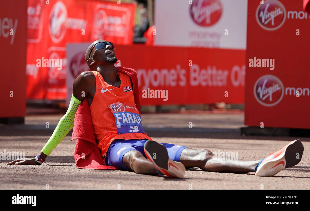 Britain's Mo Farah rests after crossing the finish line to place third ...