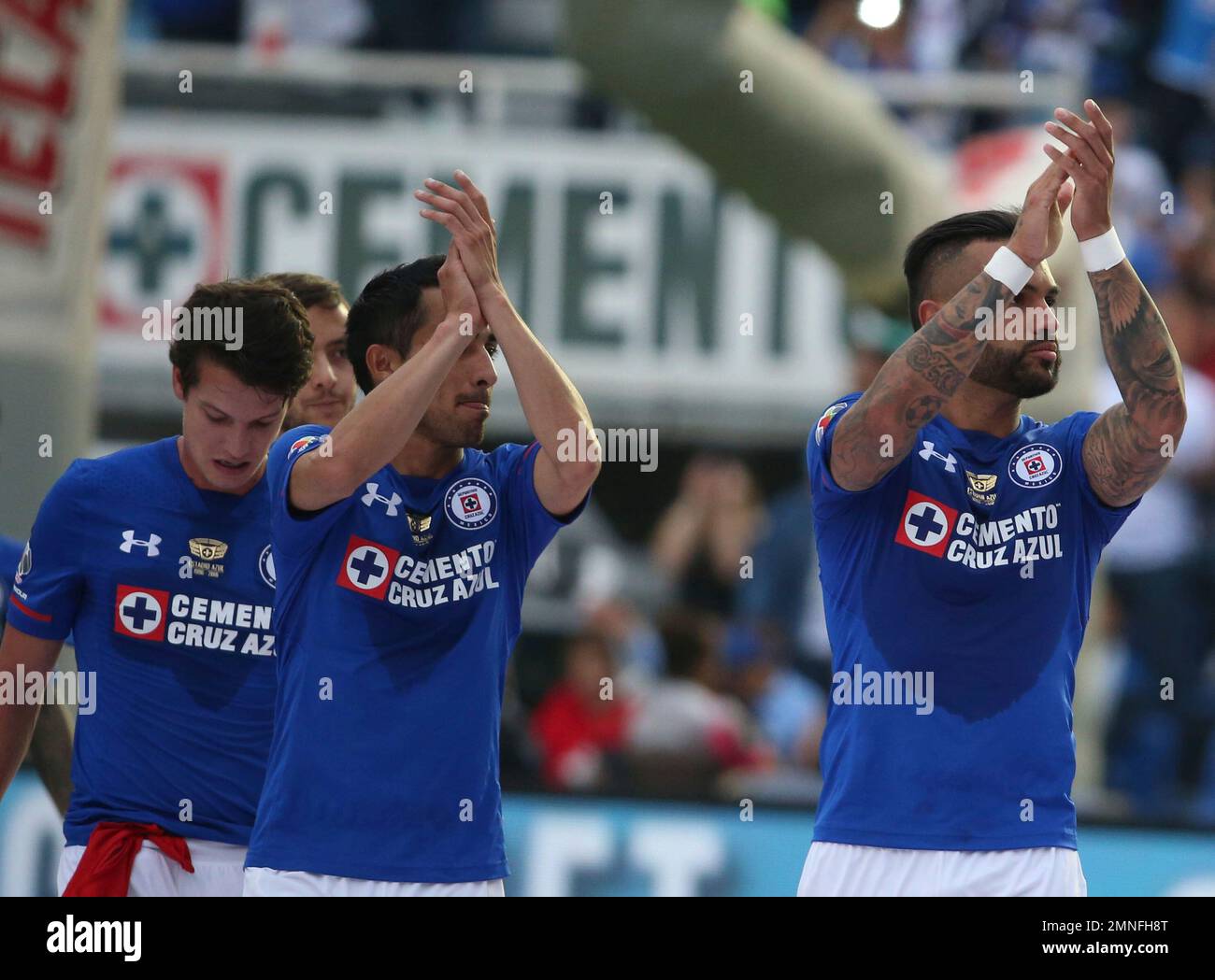 Team members of Cruz Azul make final walk around the field after a ...