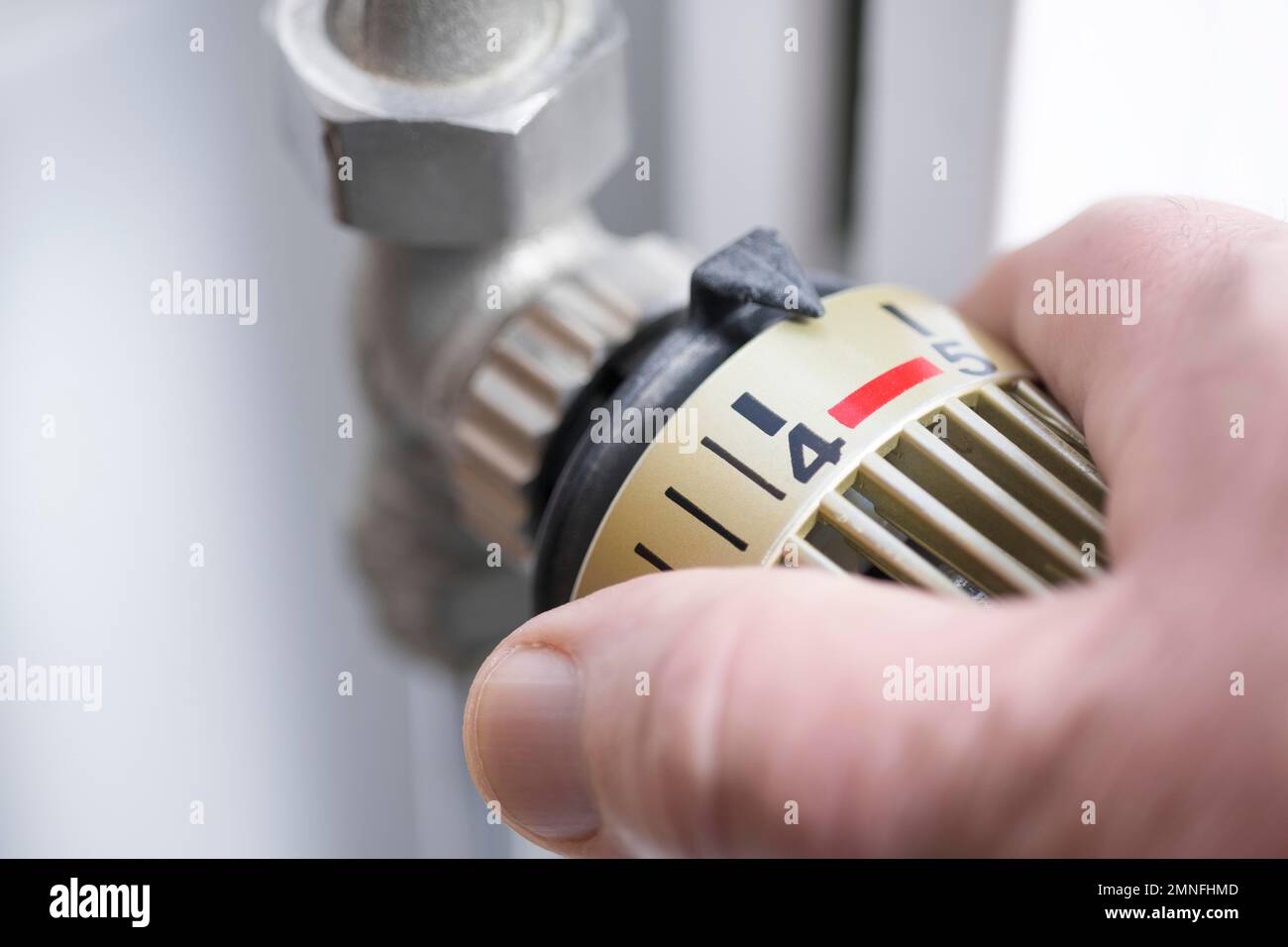 Hand turns the heating thermostat, Germany Stock Photo - Alamy