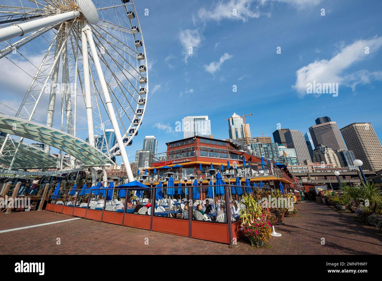 Waterfront with The Seattle Great Wheel, skyscrapers behind, Pier 57 ...