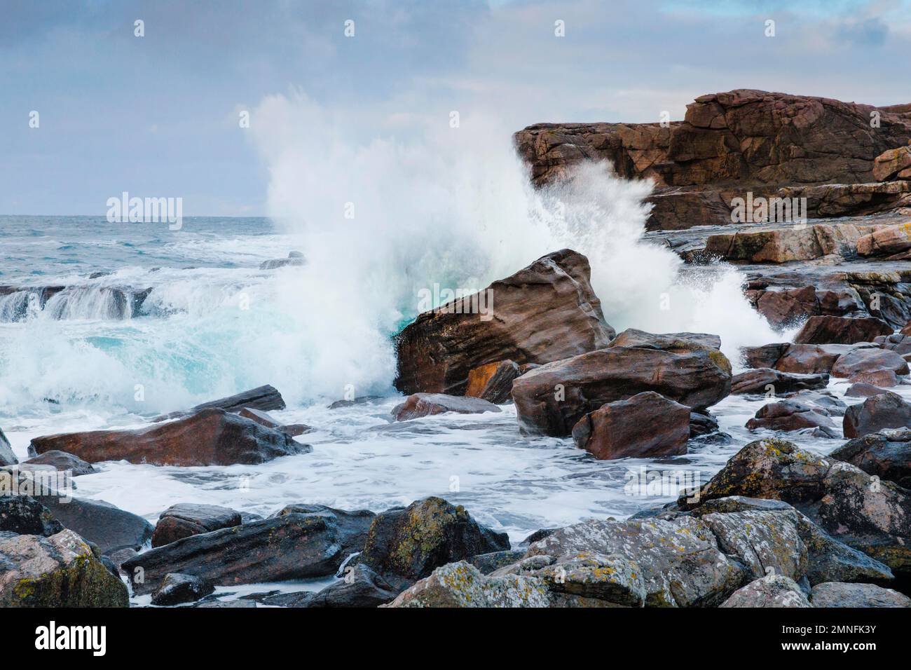 Water dashing against rocks on the rocky coast on Isle of Skye ...