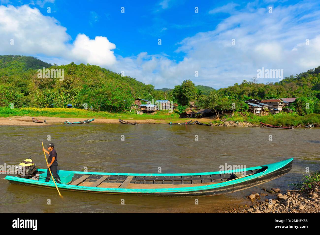 A longboat with a car engine on the Pai River, opposite the village of ...