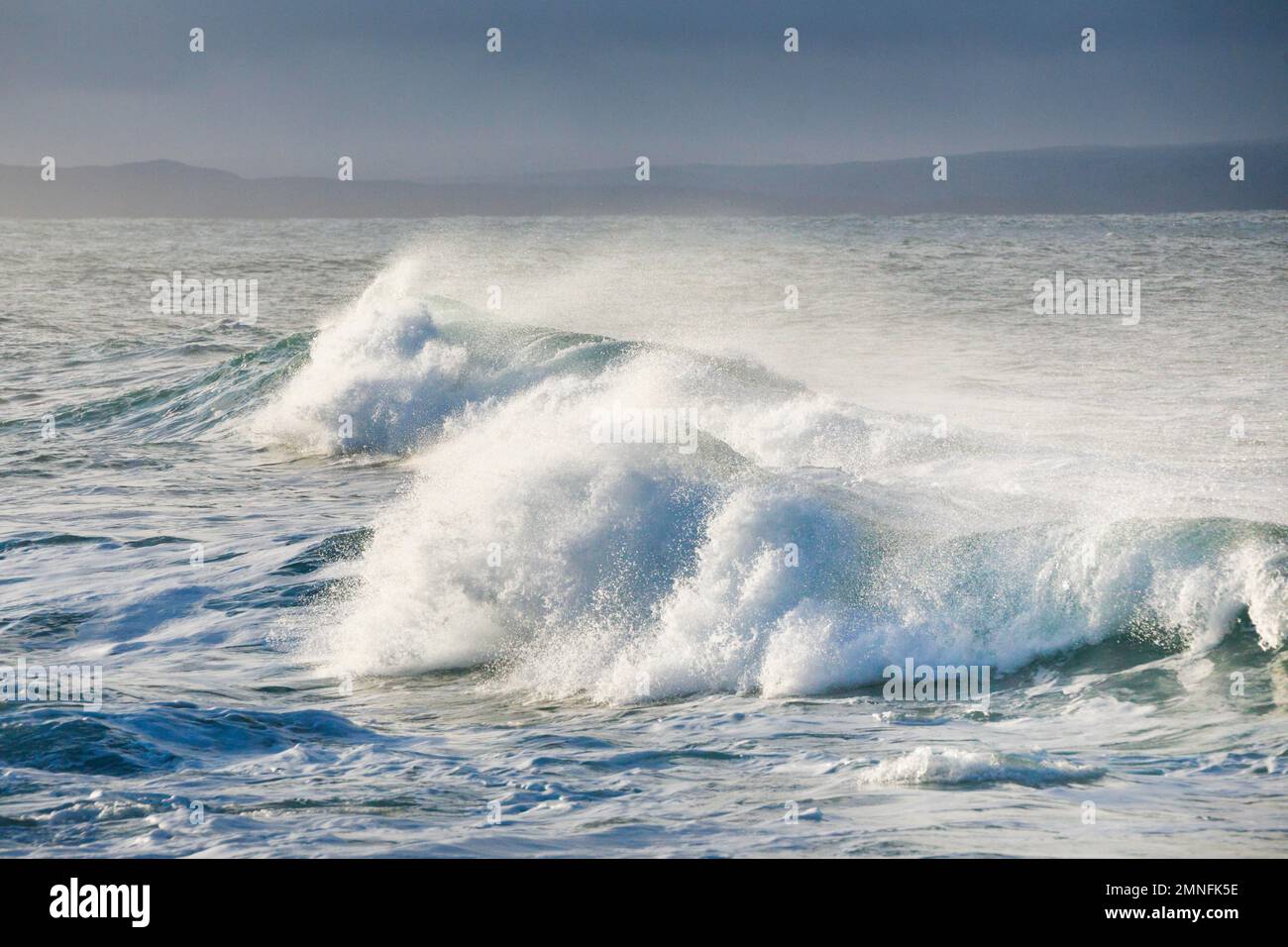 Large waves in the morning light on the open sea off the coast of Isle ...