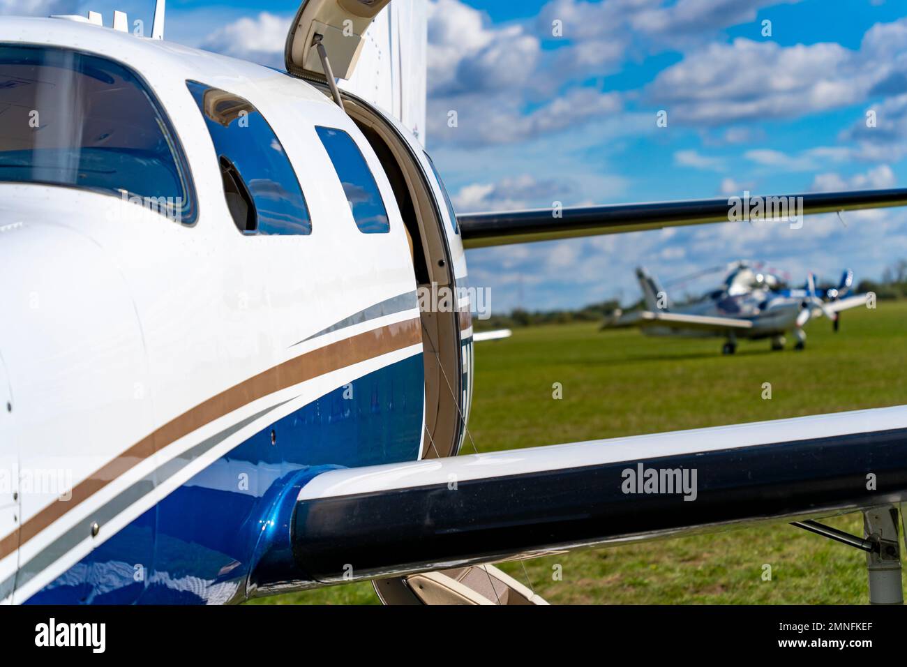 Airplane with open door at an airport Stock Photo - Alamy