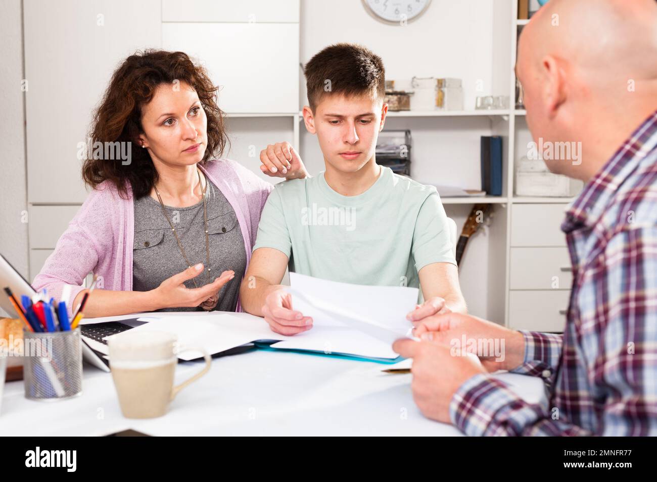 Family with son working with papers Stock Photo - Alamy