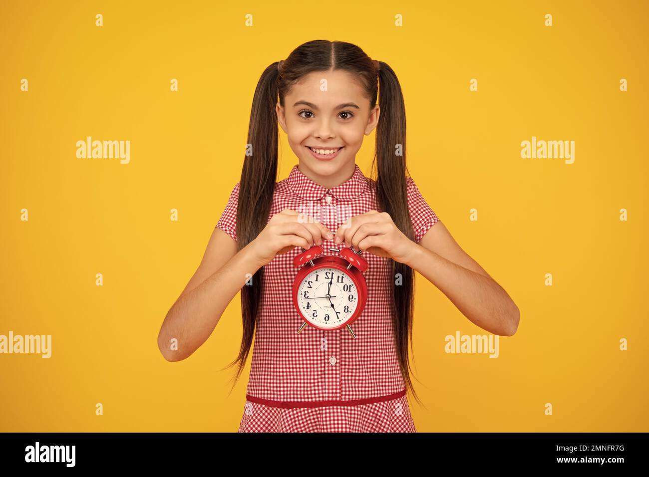 Portrait of teenage girl with clock alrm, time and deadline. Studio ...