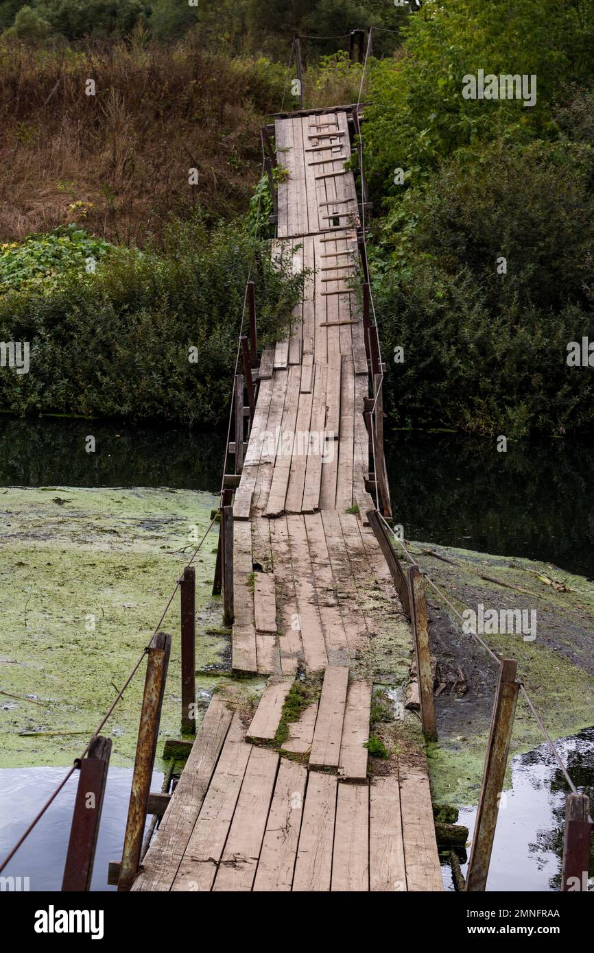 Vertical view of the footbridge over the river, skewed and lying on the ...