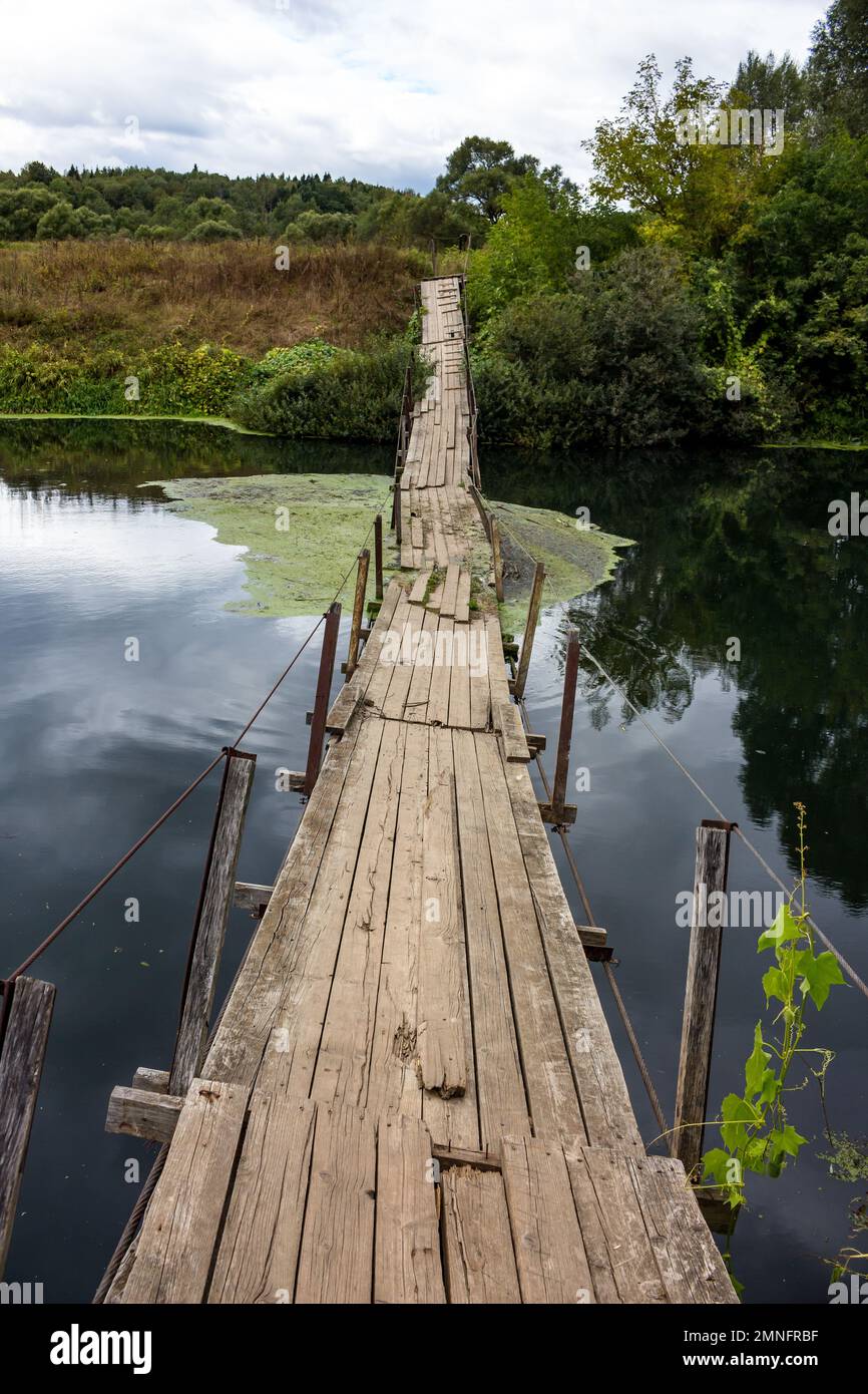 Vertical view of the footbridge over the river, skewed and lying on the ...