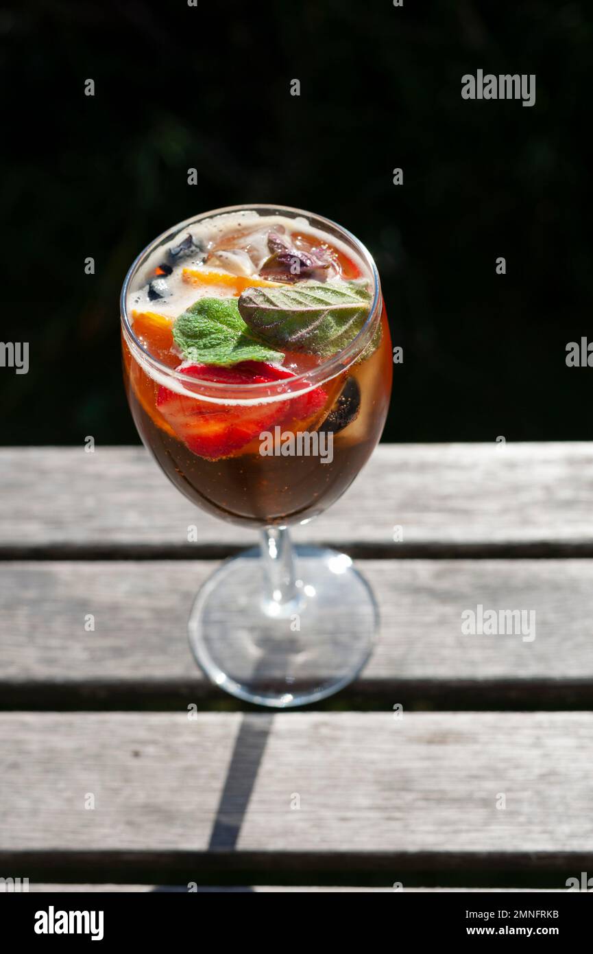 Pimm’s number 1 cup served in a wine glass on a summer’s day, and ...