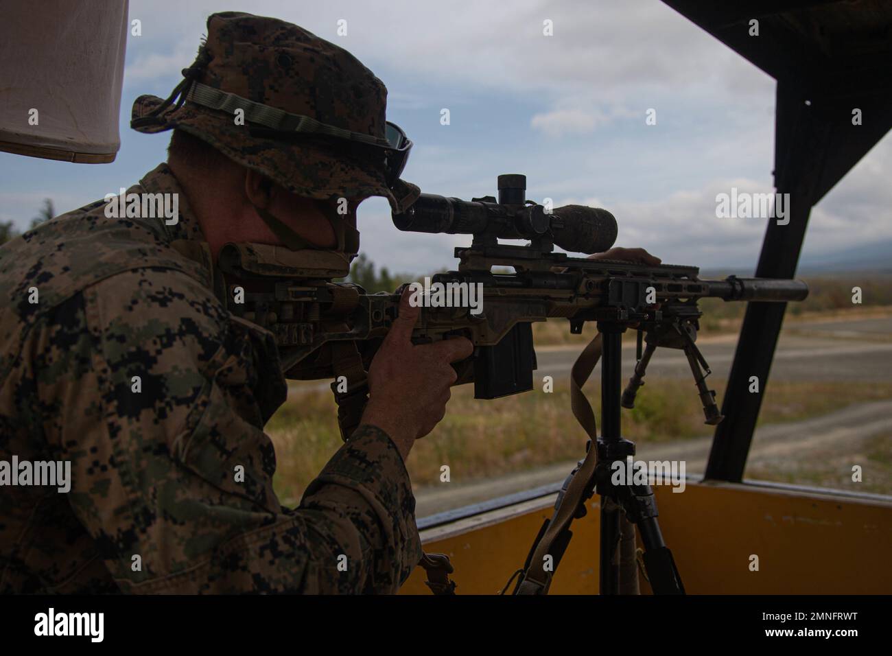 A U.S. Marine with 3d Battalion, 3d Marines, 3d Marine Division, fires ...