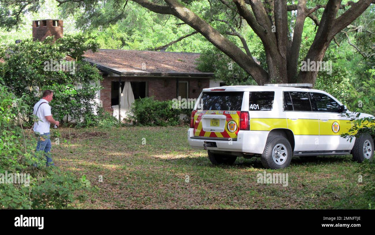 Gilchrist County Fire Rescue personnel are seen outside the home of ...