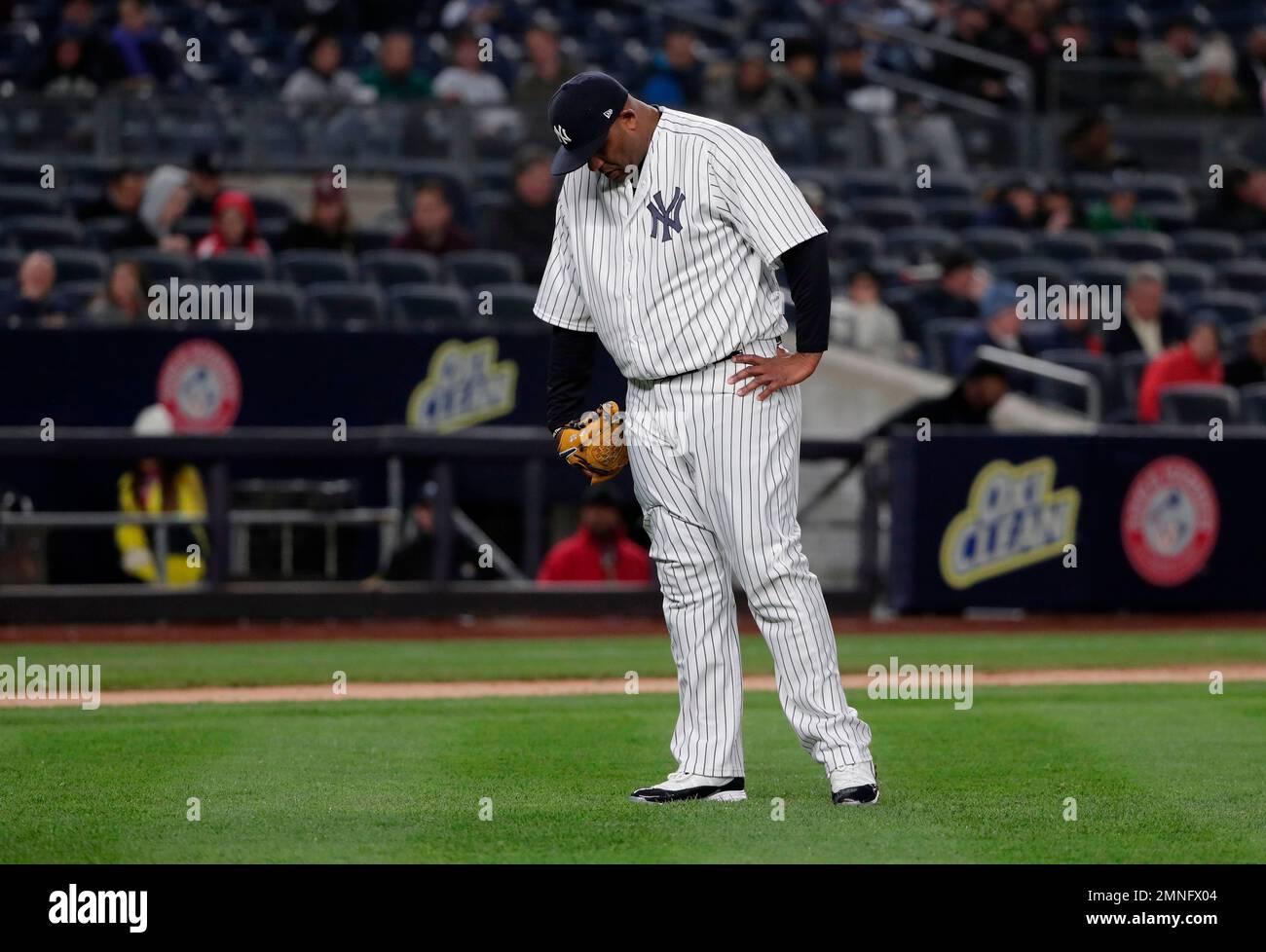 New York Yankees pitcher CC Sabathia pauses between pitches against the ...