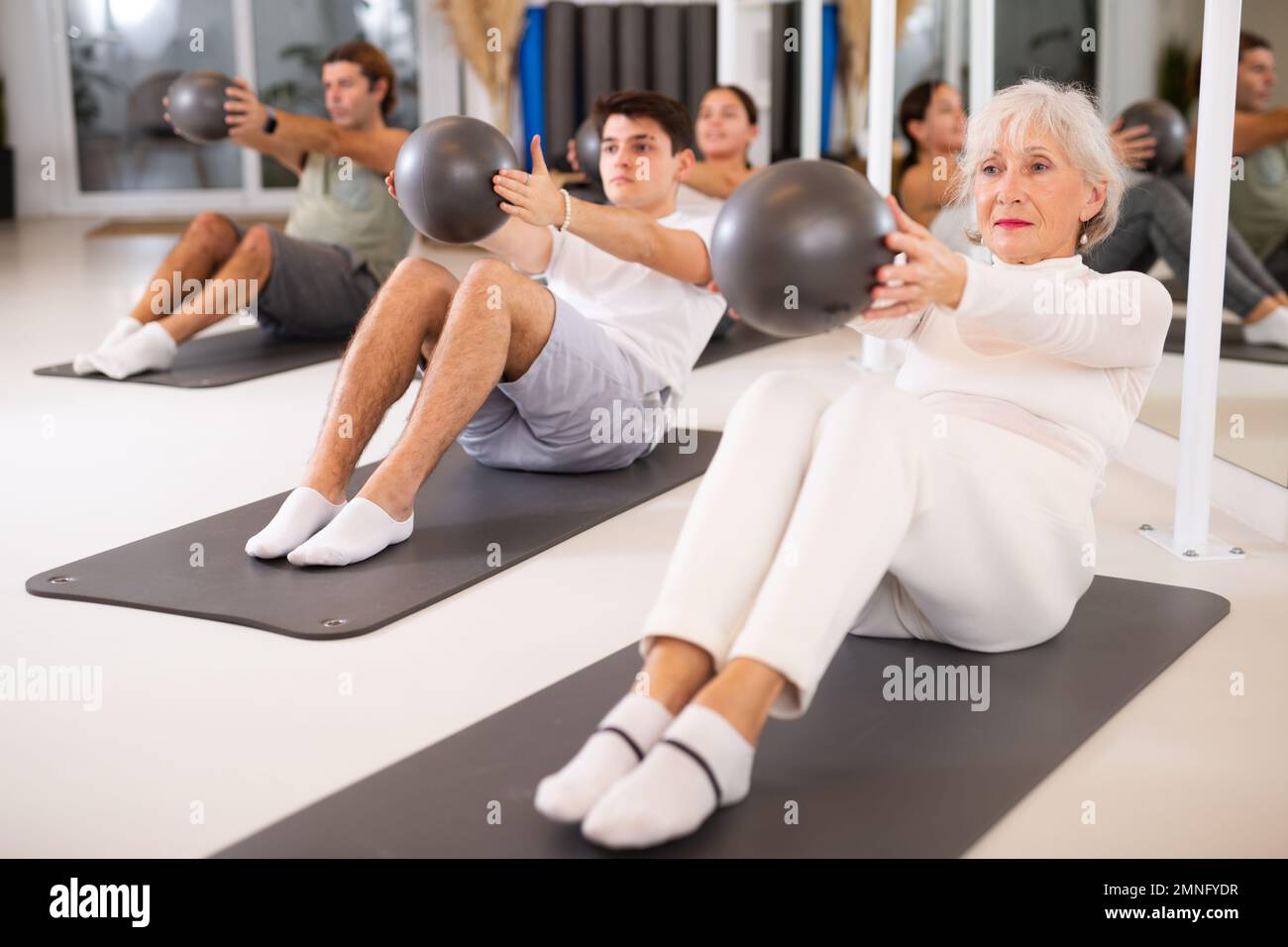 Elderly woman doing pilates with ball Stock Photo - Alamy