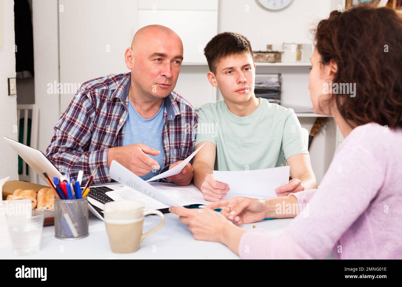 Family calculating domestic budget Stock Photo - Alamy