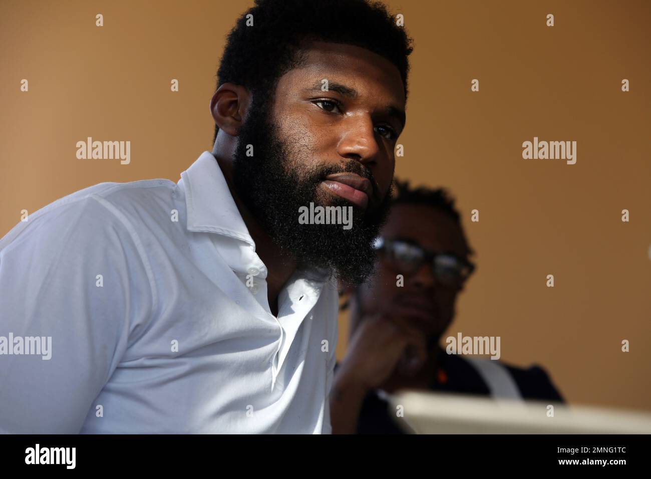 Rashon Nelson listens to a reporter's question as Donte Robinson looks on during an interview ...