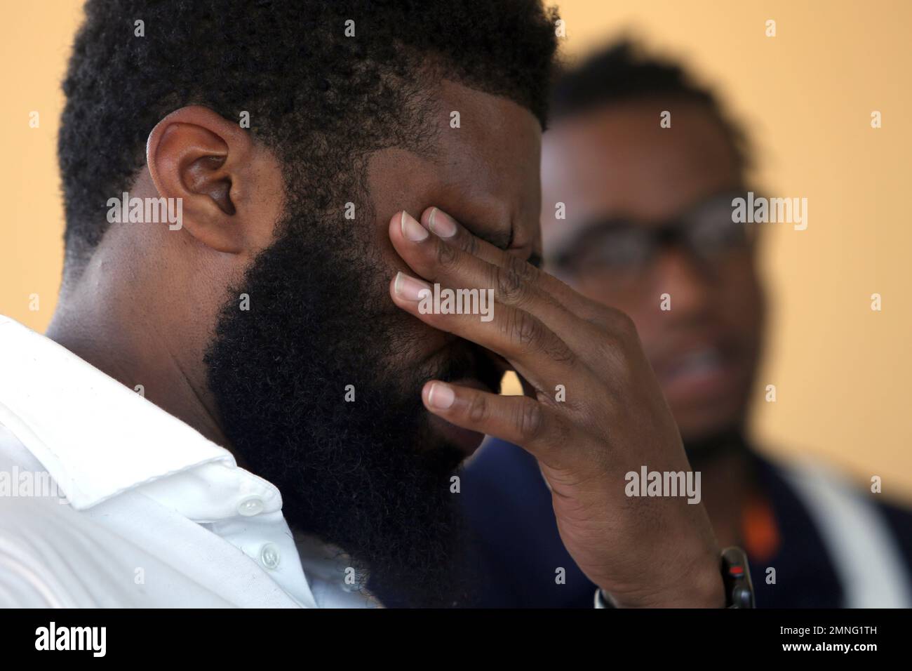 Rashon Nelson, left, rubs his eyes as Donte Robinson, right, looks on ...
