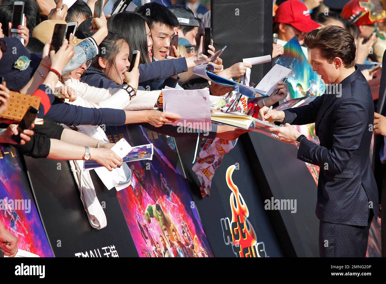 Tom Holland signs autograph during a promotional event for the latest ...