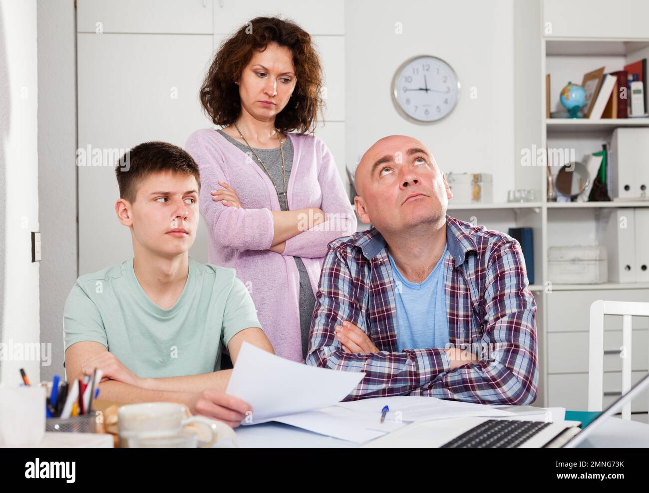 Worried family with papers Stock Photo - Alamy