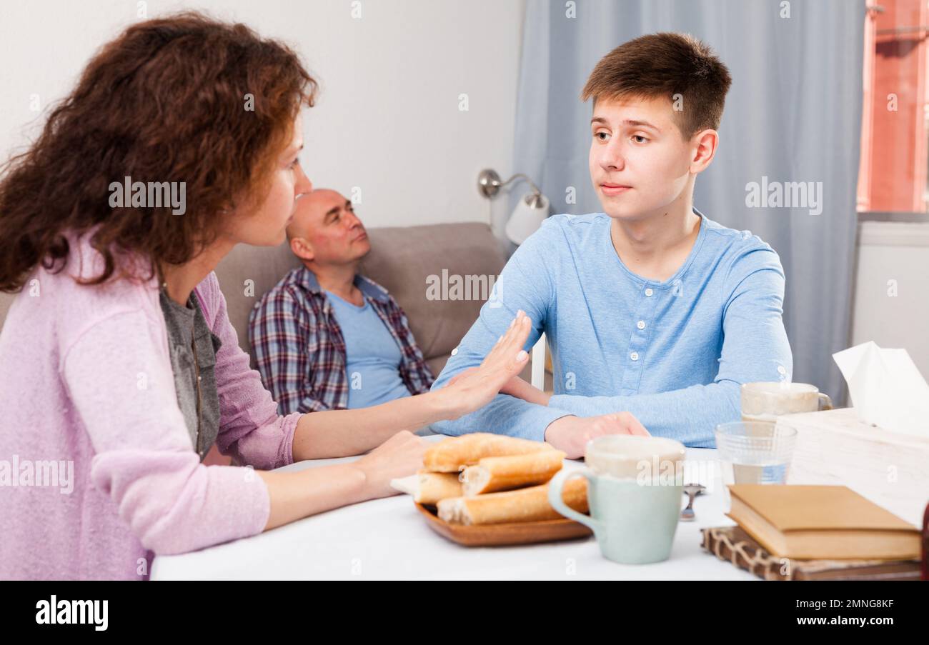 Teenager listening to reprimanding mother Stock Photo - Alamy
