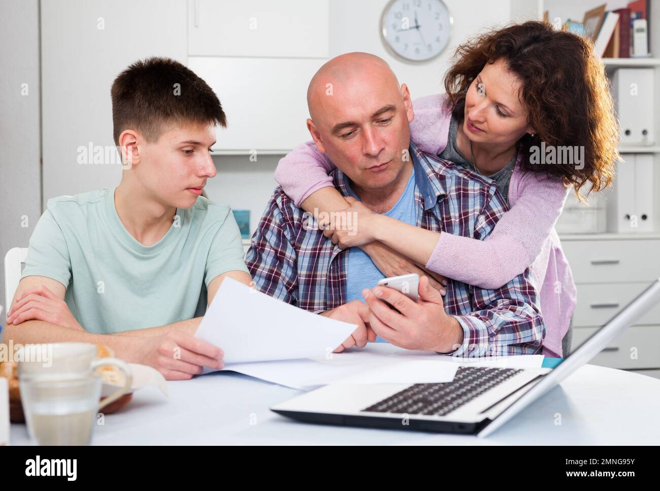 Family with son working with papers Stock Photo - Alamy