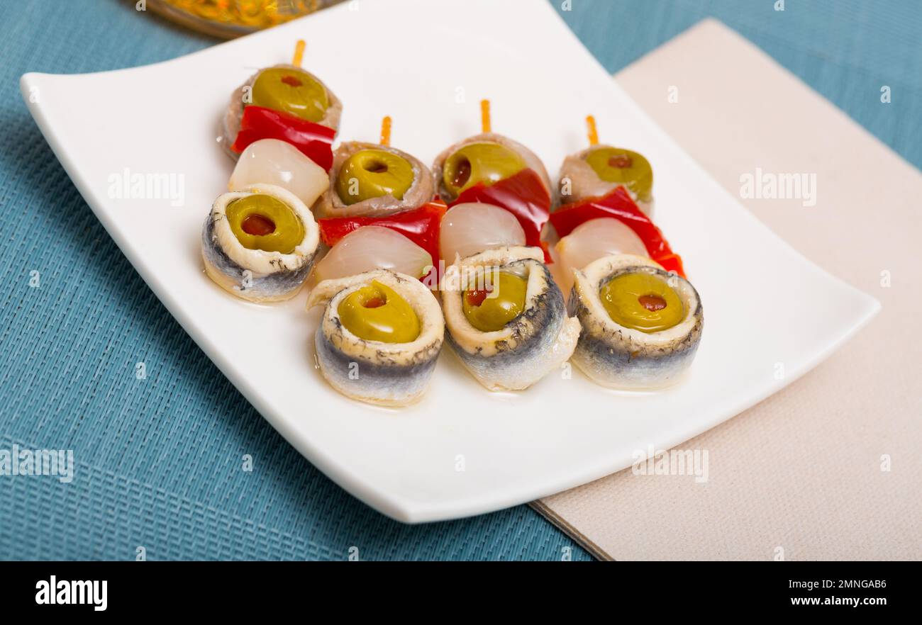 Pickled anchovy rolls with olives, pepper, onion Stock Photo - Alamy