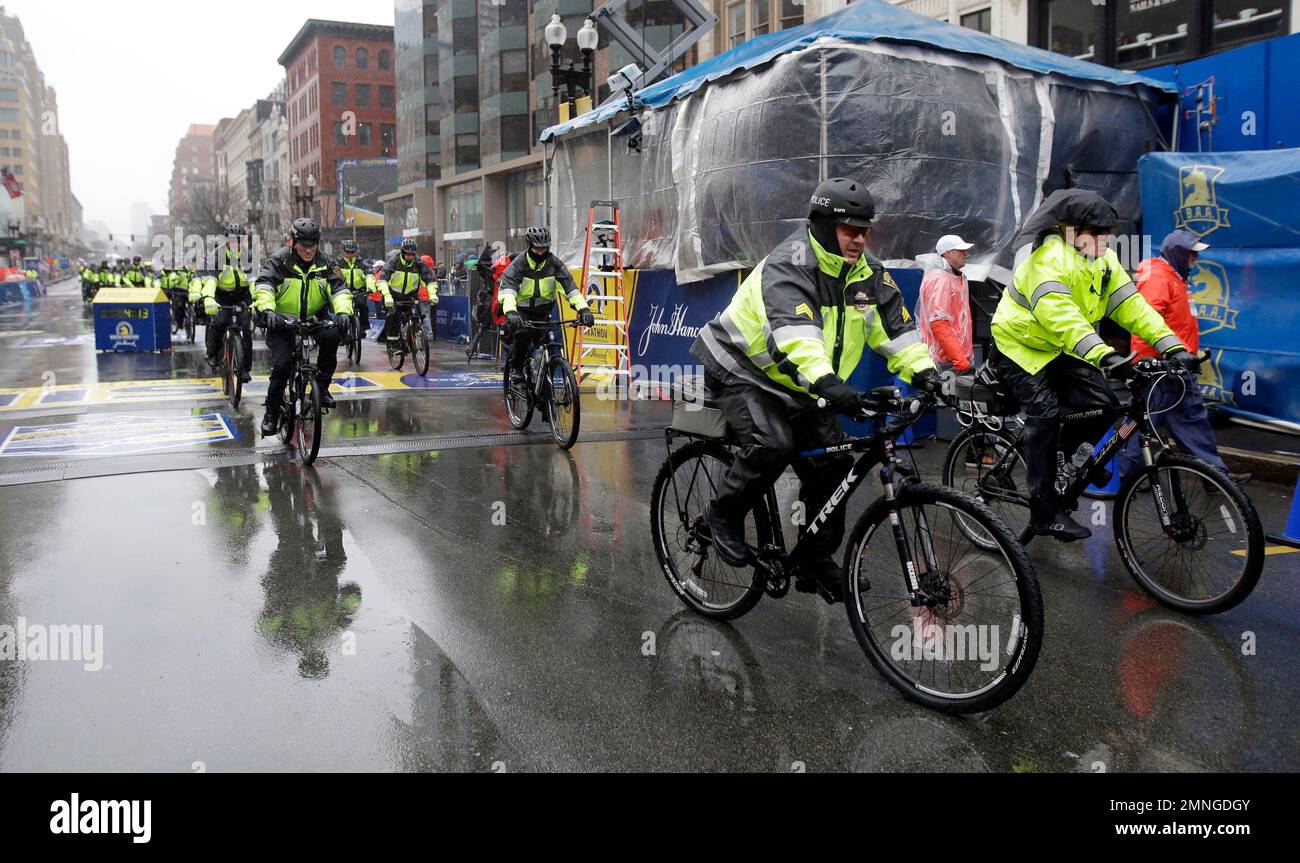 Bicycle-mounted police officers patrol at the finish line before the ...
