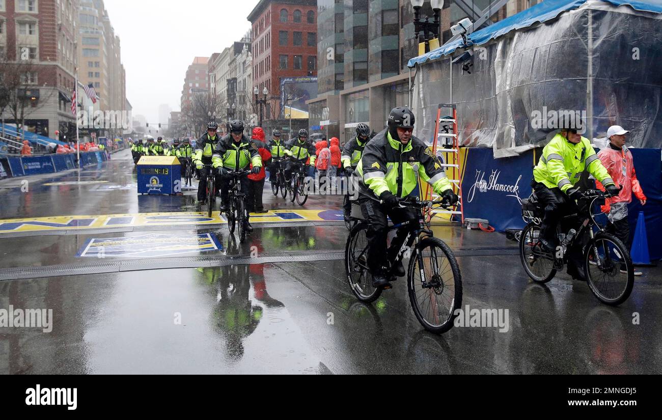 Bicycle-mounted police officers patrol at the finish line before the ...