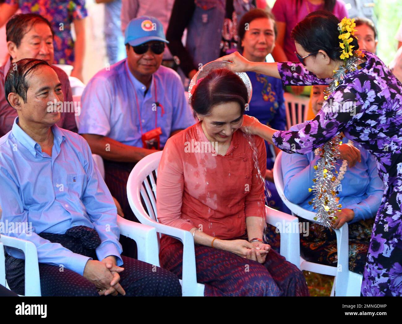 Myanmar's leader Aung San Suu Kyi, center, is doused with water as she ...