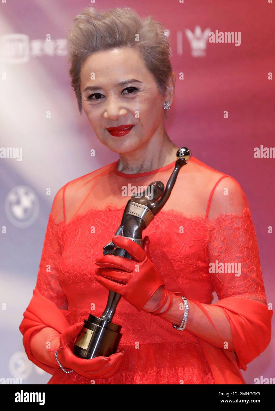 Hong Kong actress Deanie Ip poses after winning the Best Supporting Actress award for her movie ...