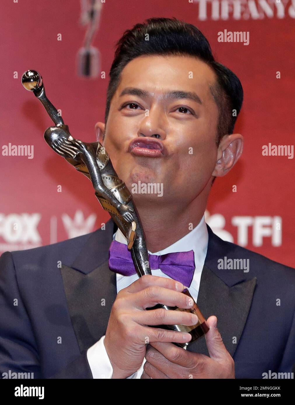 Hong Kong actor Louis Koo poses after winning the Best Actor award for ...