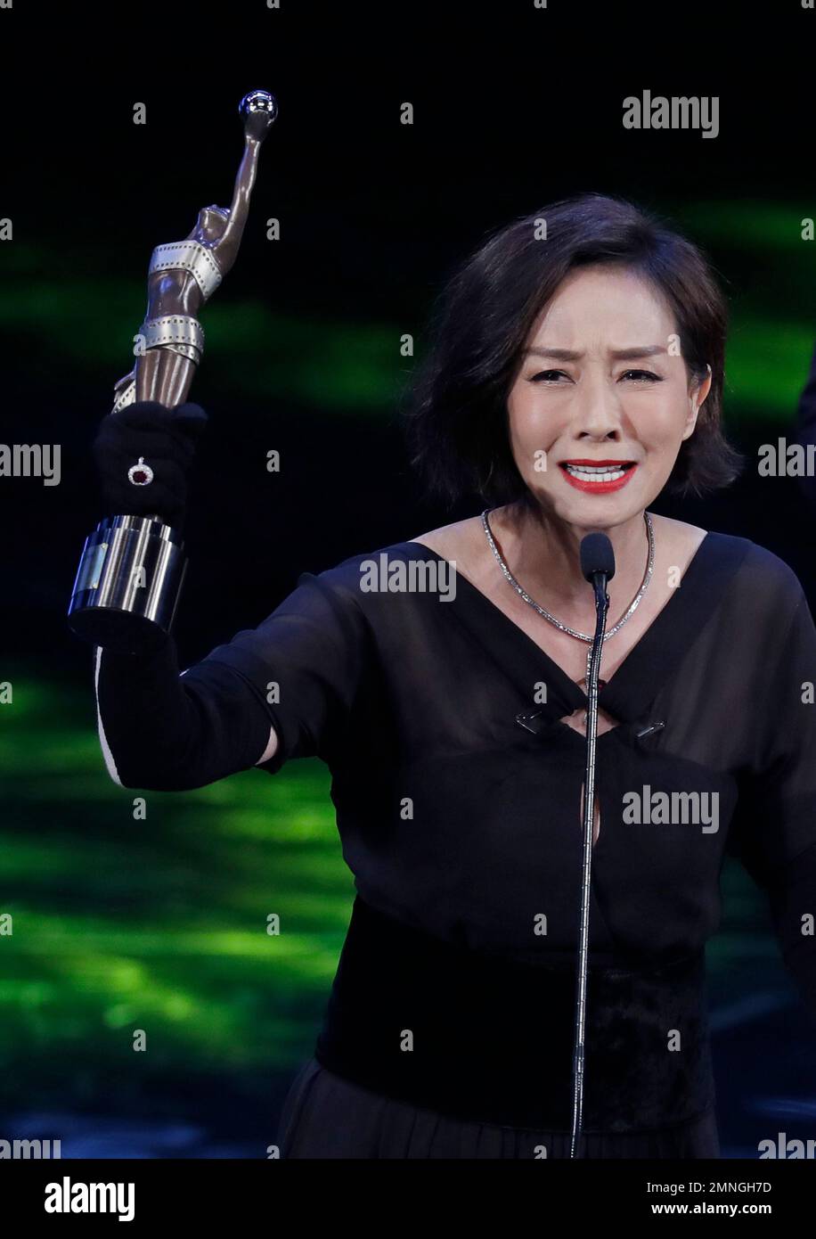 Hong Kong actress Teresa Mo raises her Best Actress award for her movie ...